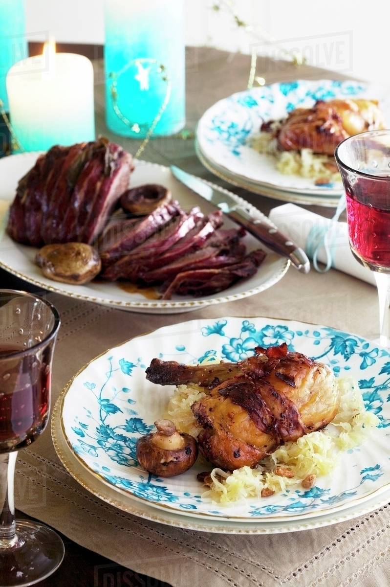 Pheasant wrapped in bacon on a bed of sauerkraut - Stock Photo - Dissolve