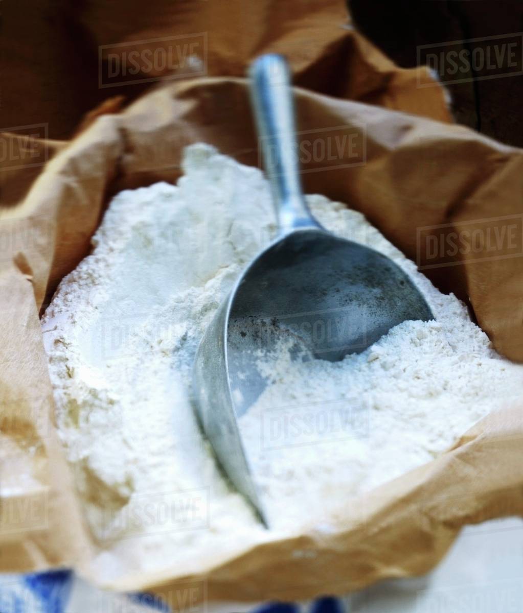 Flour in a paper sack with a scoop - Royalty-free Stock Photo | Dissolve