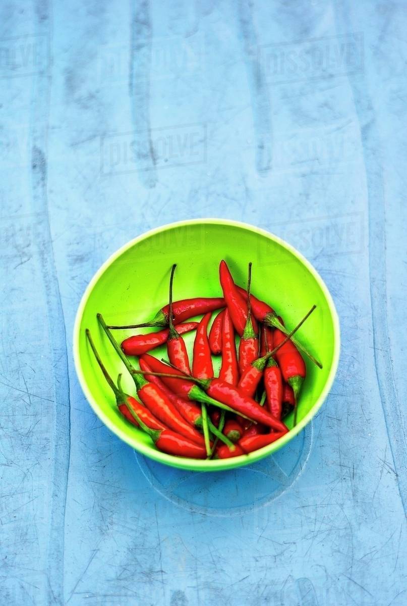 Fresh red chilli peppers in a green bowl - Royalty-free Stock Photo ...