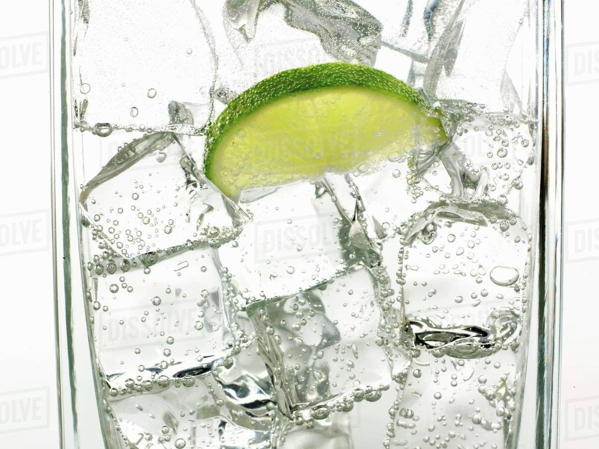 Mineral water with ice cubes and a slice of lime - Royalty-free Stock Photo | Dissolve