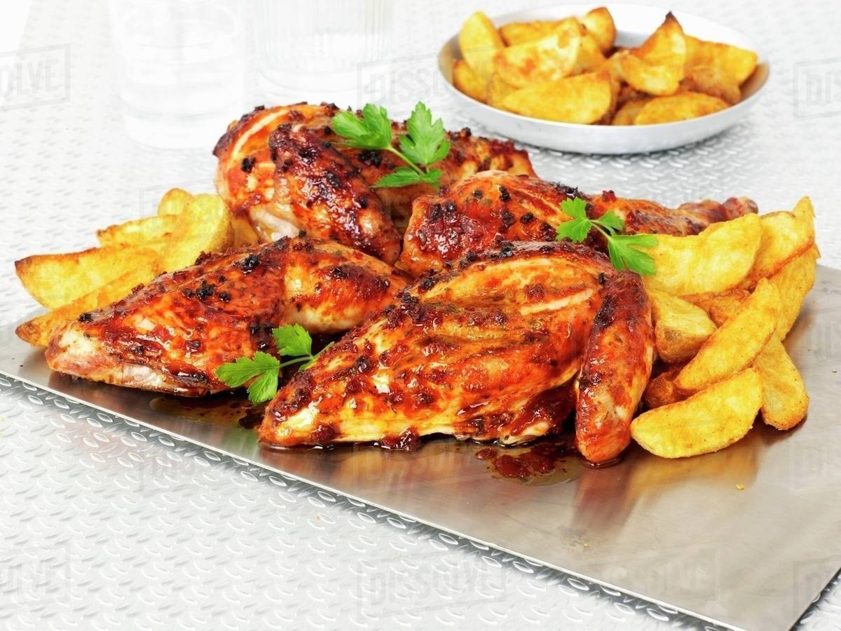 Sticky chicken with chips (England) - Royalty-free Stock Photo | Dissolve