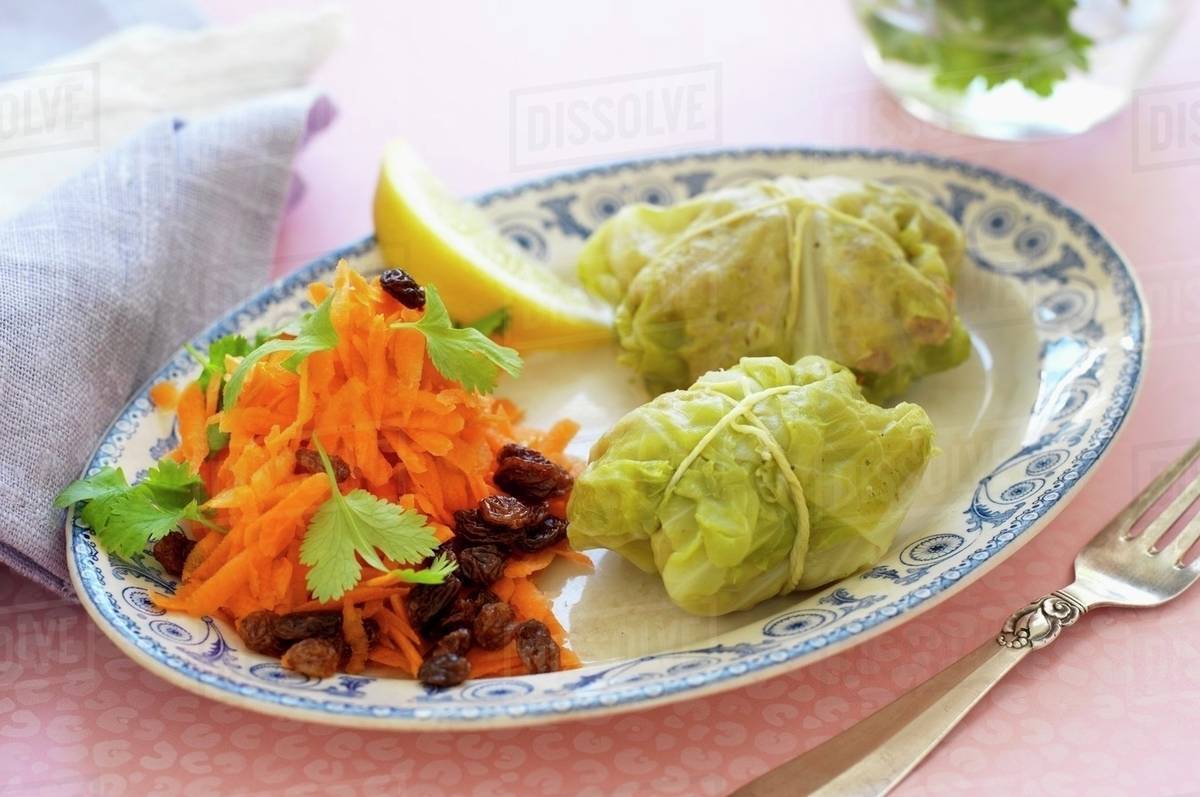 Savoy cabbage parcels filled with minced meat served with a raw carrot ...