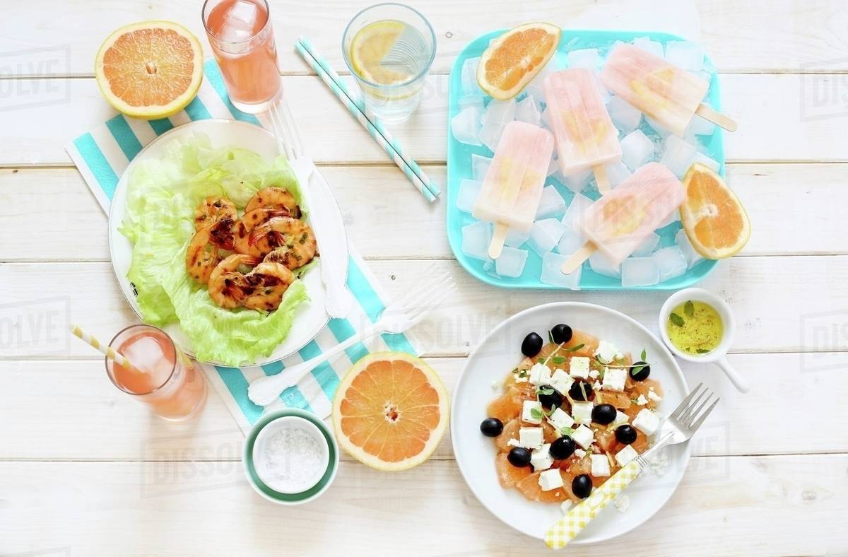 A summer buffet featuring grapefruit dishes and drinks - Royalty-free ...