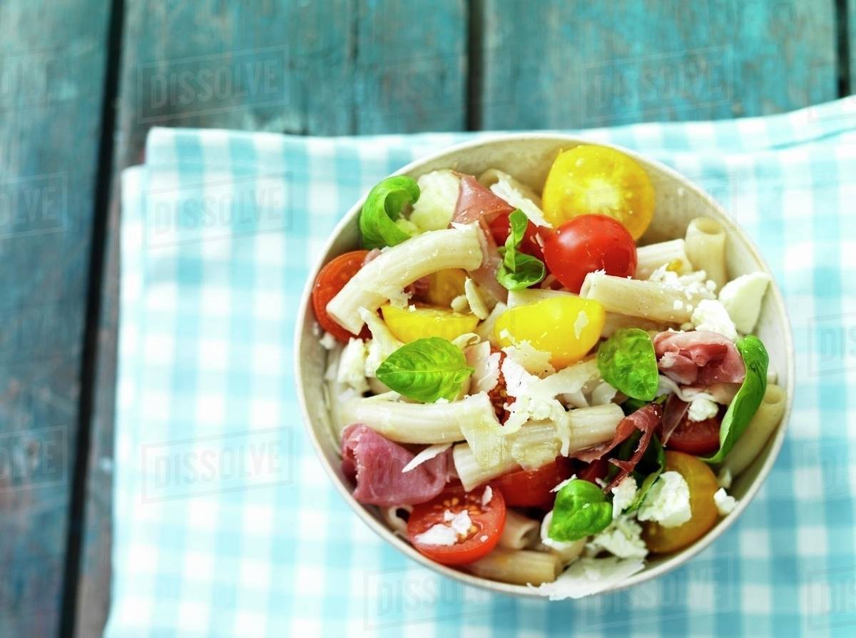 Pasta salad with Serrano ham and tomatoes - Royalty-free Stock Photo ...