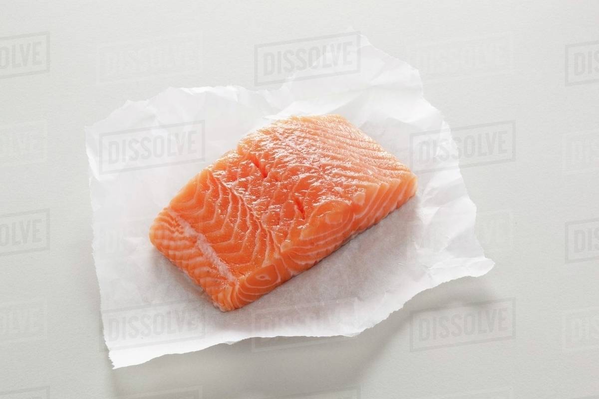 A fresh salmon fillet on a piece of paper - Royalty-free Stock Photo ...