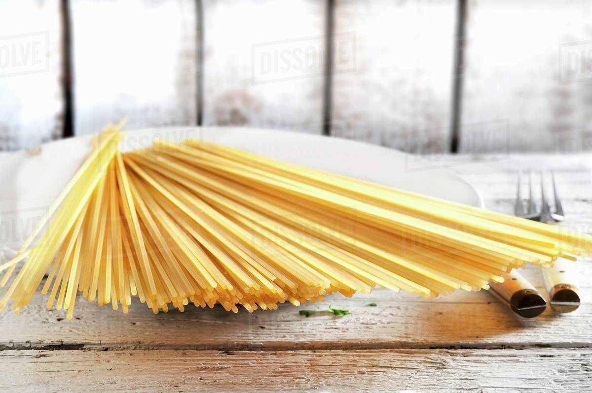 Raw spaghetti on a plate - Stock Photo - Dissolve