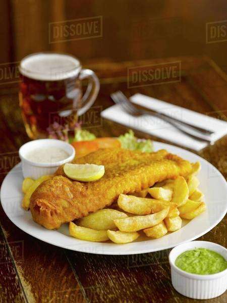 Fish and chips with sauces and beer in a pub - Royalty-free Stock Photo ...