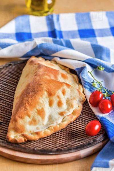 Calzone caprese (pizza pocket with tomatoes and mozzarella, Italy ...