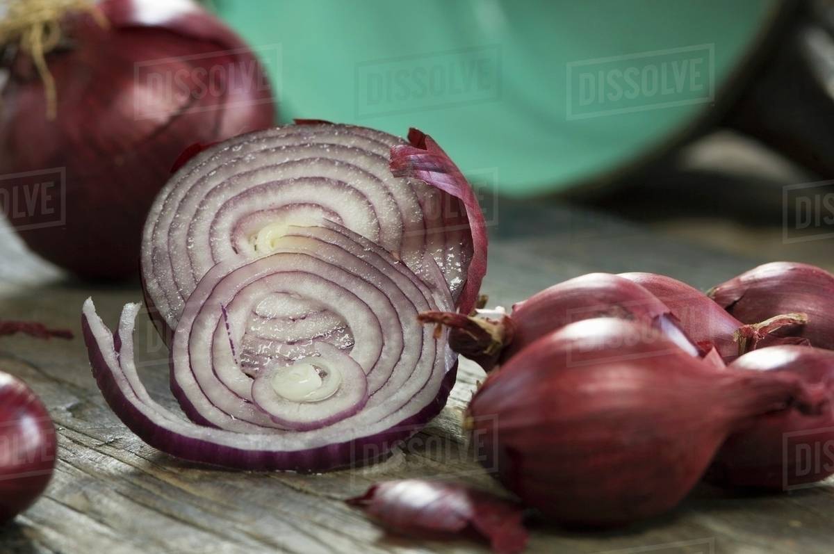 Large and small red onions, sliced on a chopping board - Royalty-free ...
