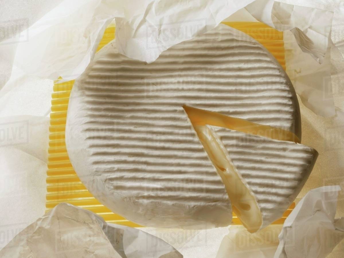 Brie, sliced, on paper - Stock Photo - Dissolve
