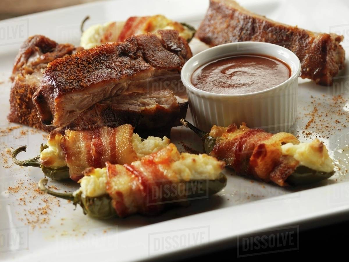 Baby Back Ribs with Bacon Wrapped Cream Cheese Filled Jalapenos - Stock ...
