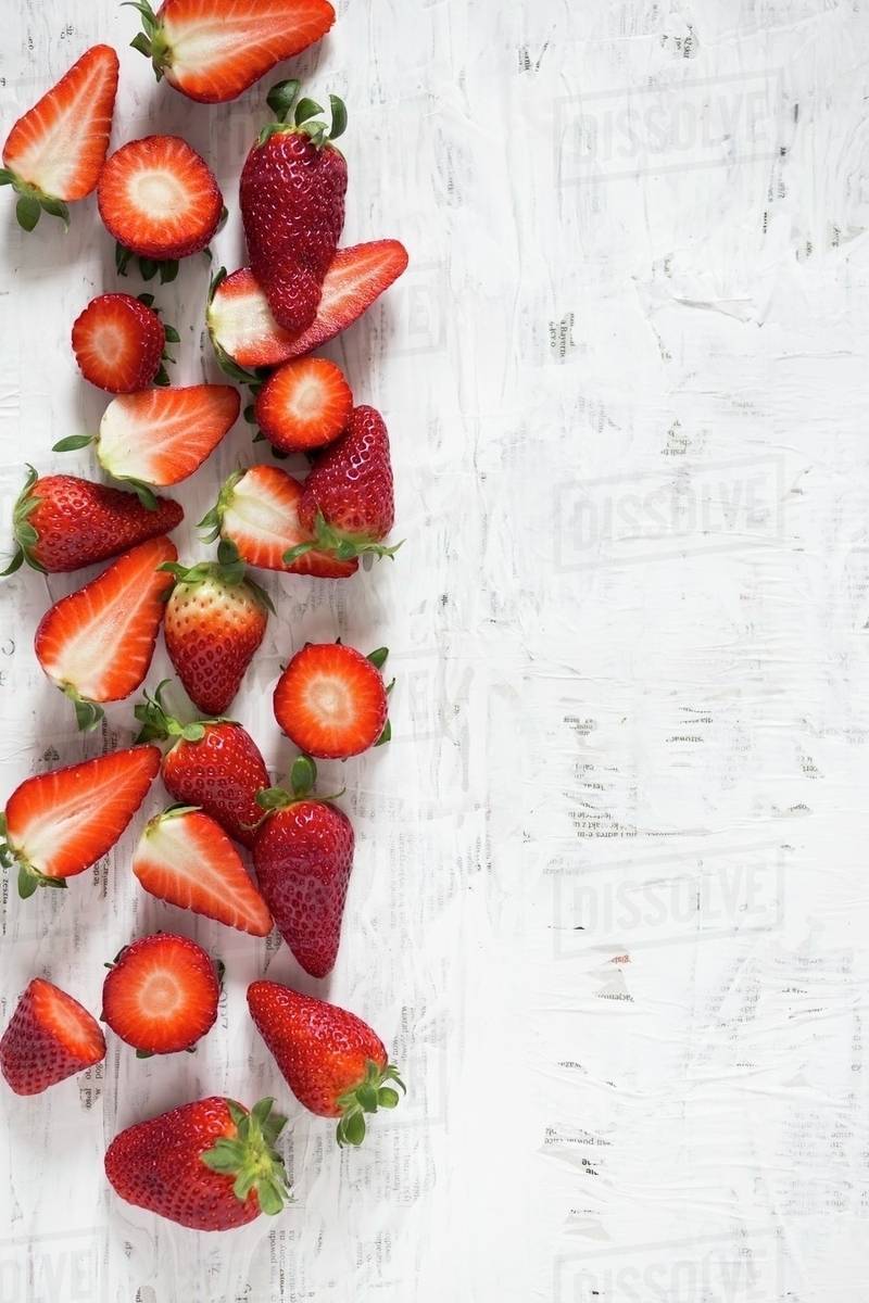 Strawberries on a white surface - Stock Photo - Dissolve