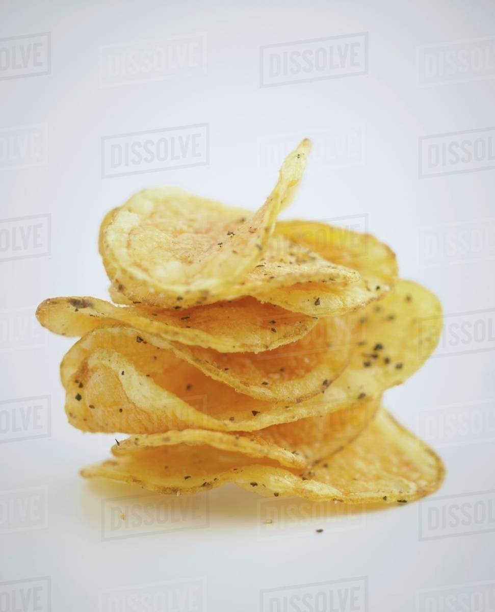 A stack of crisps on a white surface - Royalty-free Stock Photo | Dissolve