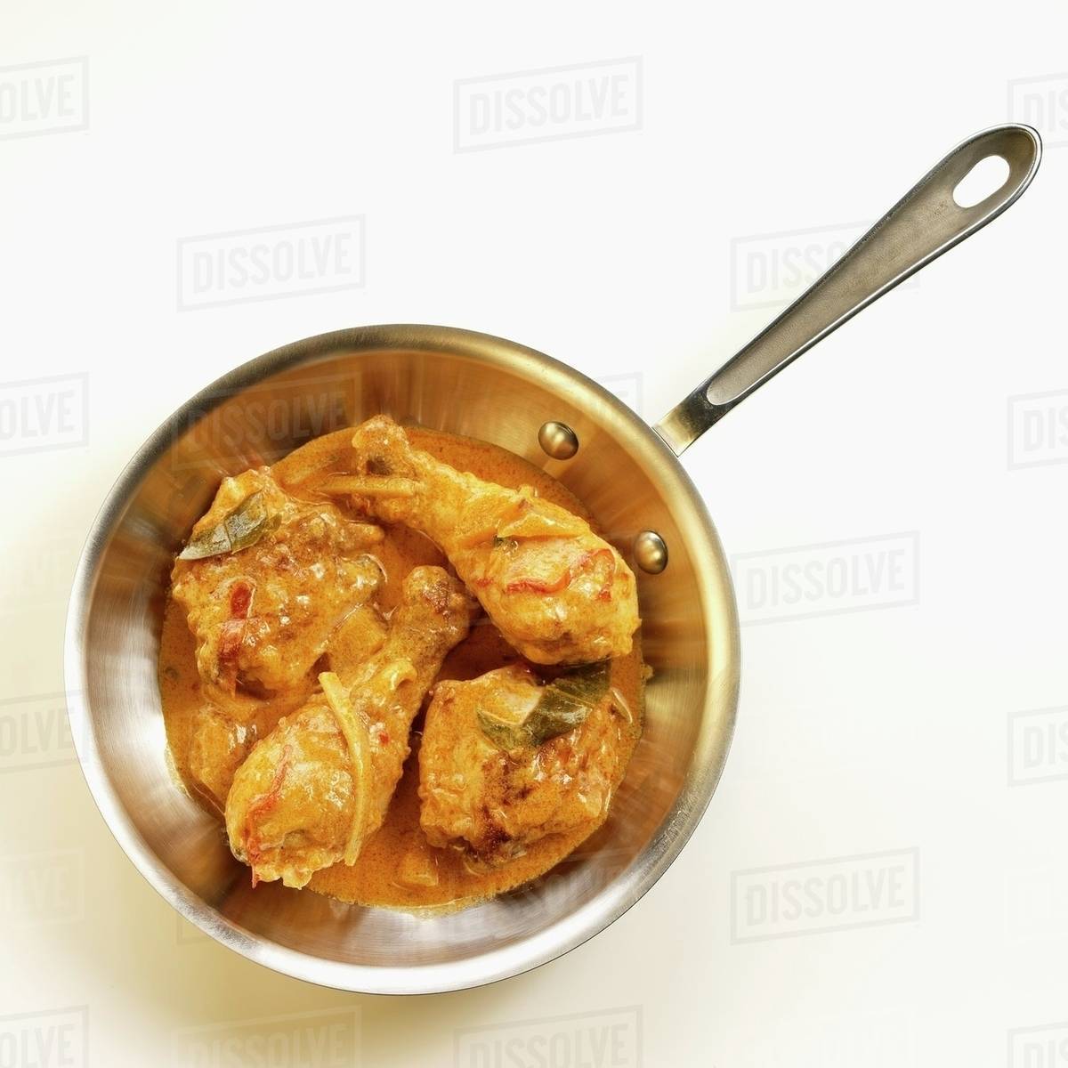 Chicken bit in a red curry sauce in a pan - Royalty-free Stock Photo ...