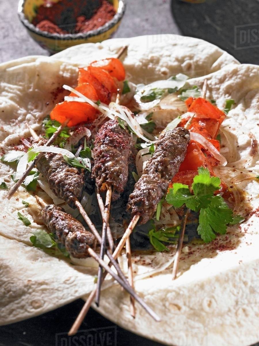 Spicy kebabs on unleavened bread - Royalty-free Stock Photo | Dissolve