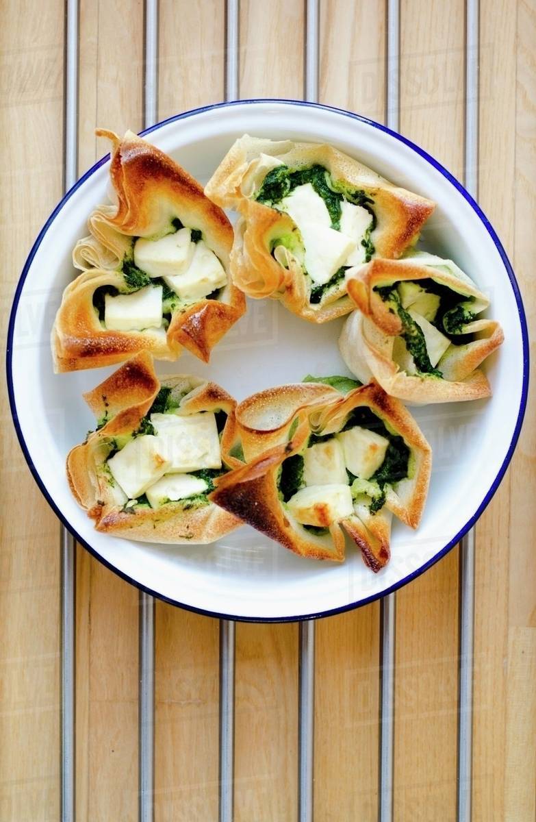 Filo pastry packets filled with feta cheese and spinach (Greece ...