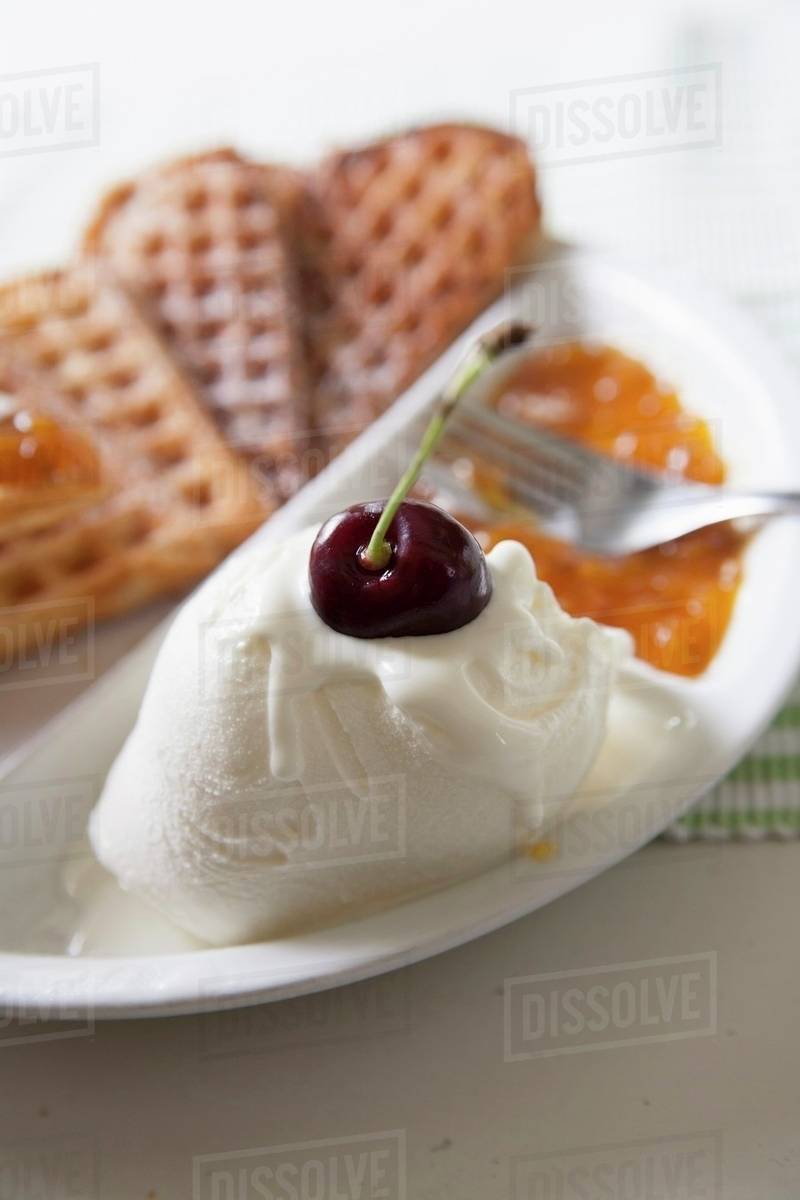 Heart-shaped waffles with vanilla ice cream and cloudberry jam ...
