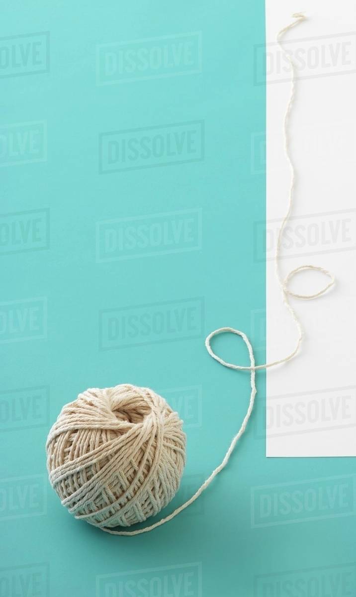 A ball of twine on a light-blue surface - Royalty-free Stock Photo ...