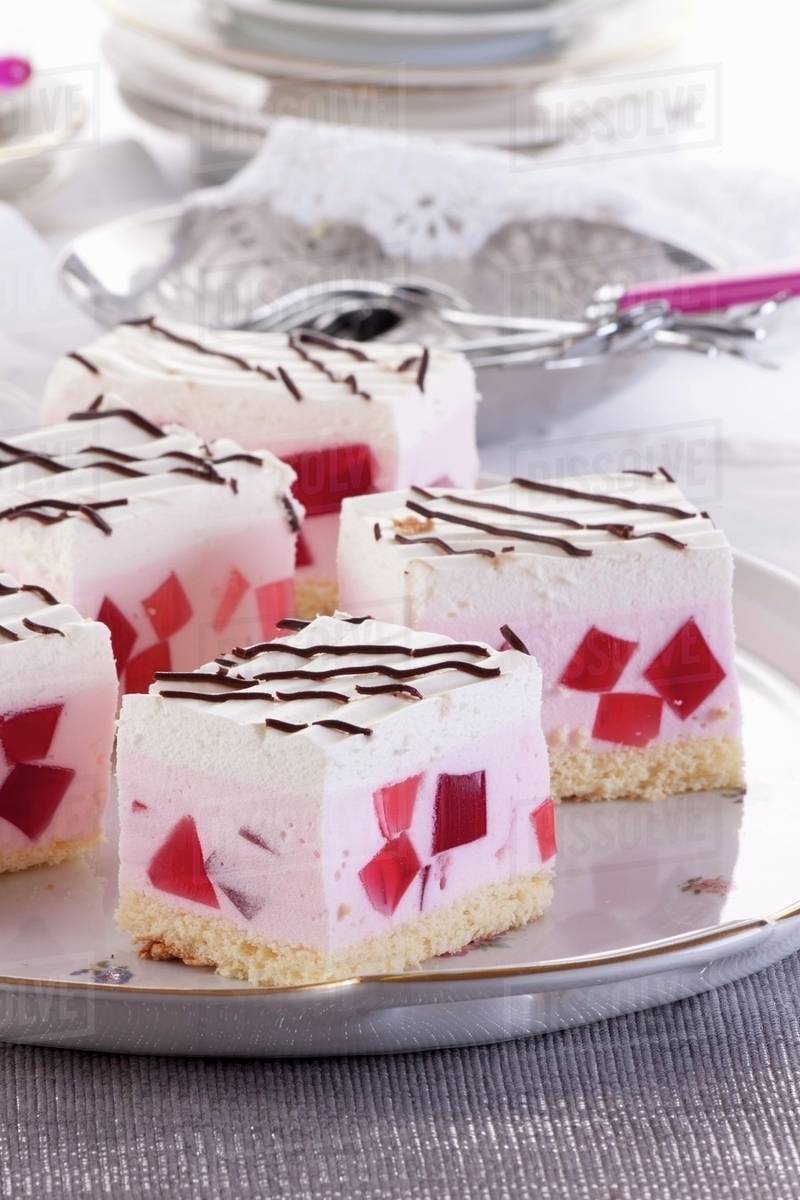 Cream slices with red jelly cubes - Royalty-free Stock Photo | Dissolve