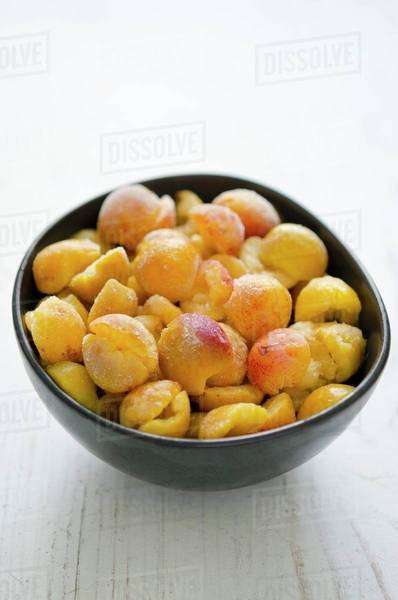 Frozen mirabelle plums in a bowl - Stock Photo - Dissolve