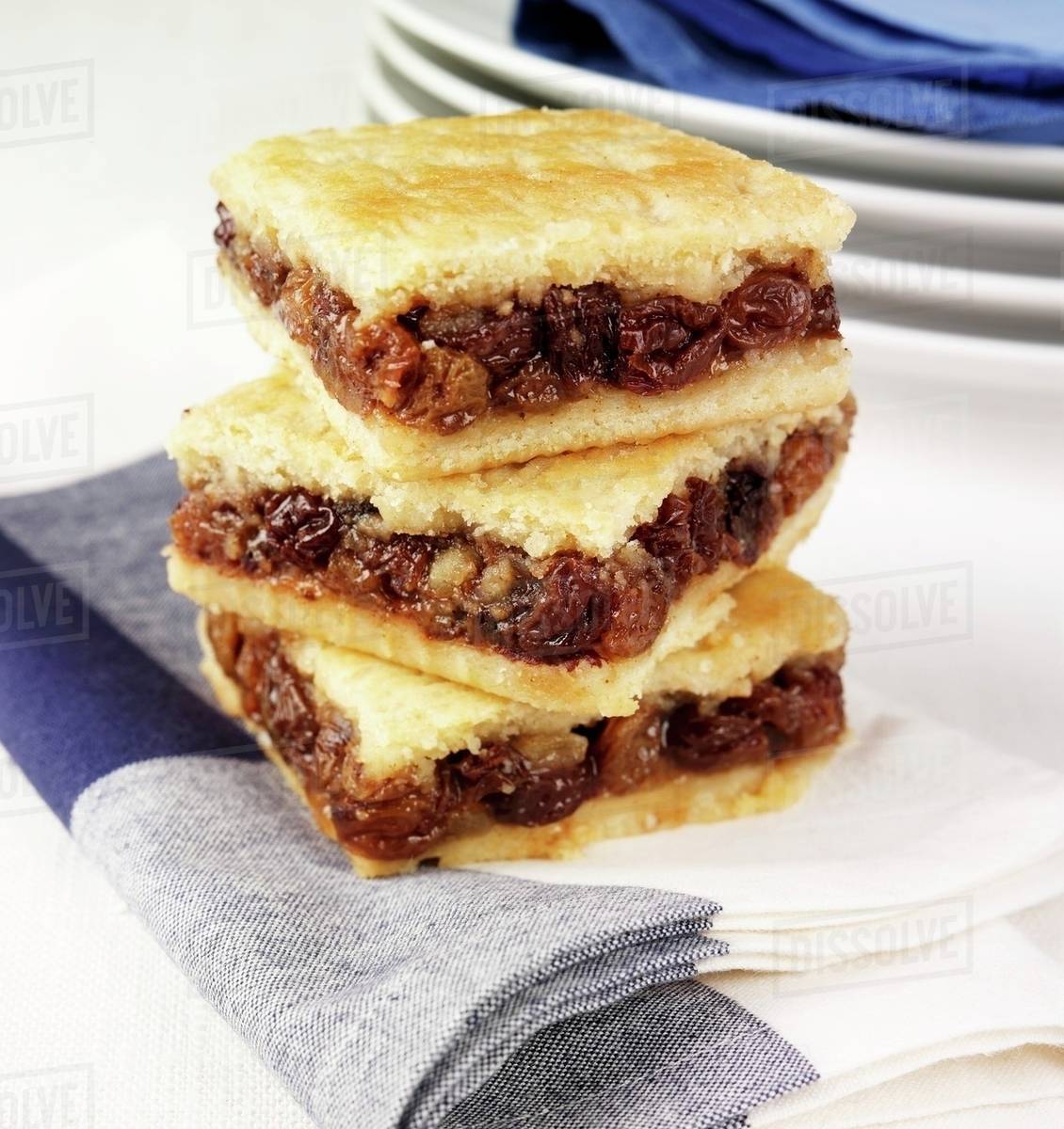 A stack of pastry slices with dried fruit filling - Stock Photo - Dissolve