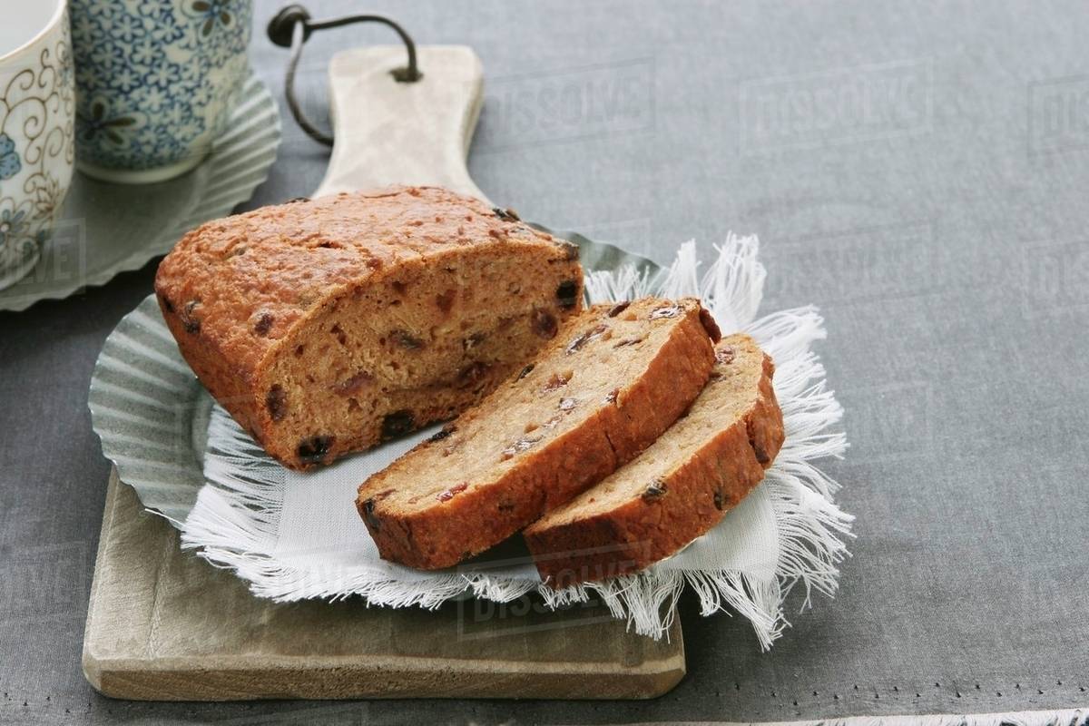Home-made fruit loaf, partly sliced - Royalty-free Stock Photo | Dissolve