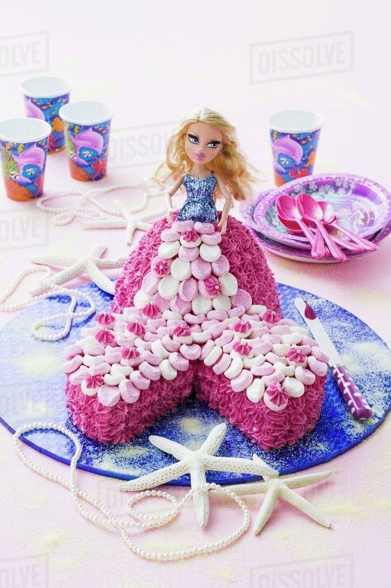 A child's birthday cake with a mermaid doll - Stock Photo - Dissolve