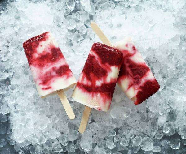 Ice lollies (raspberry and vanilla) on ice cubes - Royalty-free Stock ...