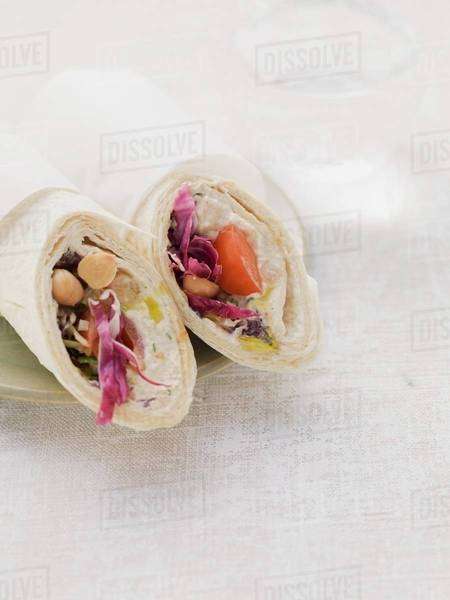 Wraps filled with houmous and tomatoes - Stock Photo - Dissolve