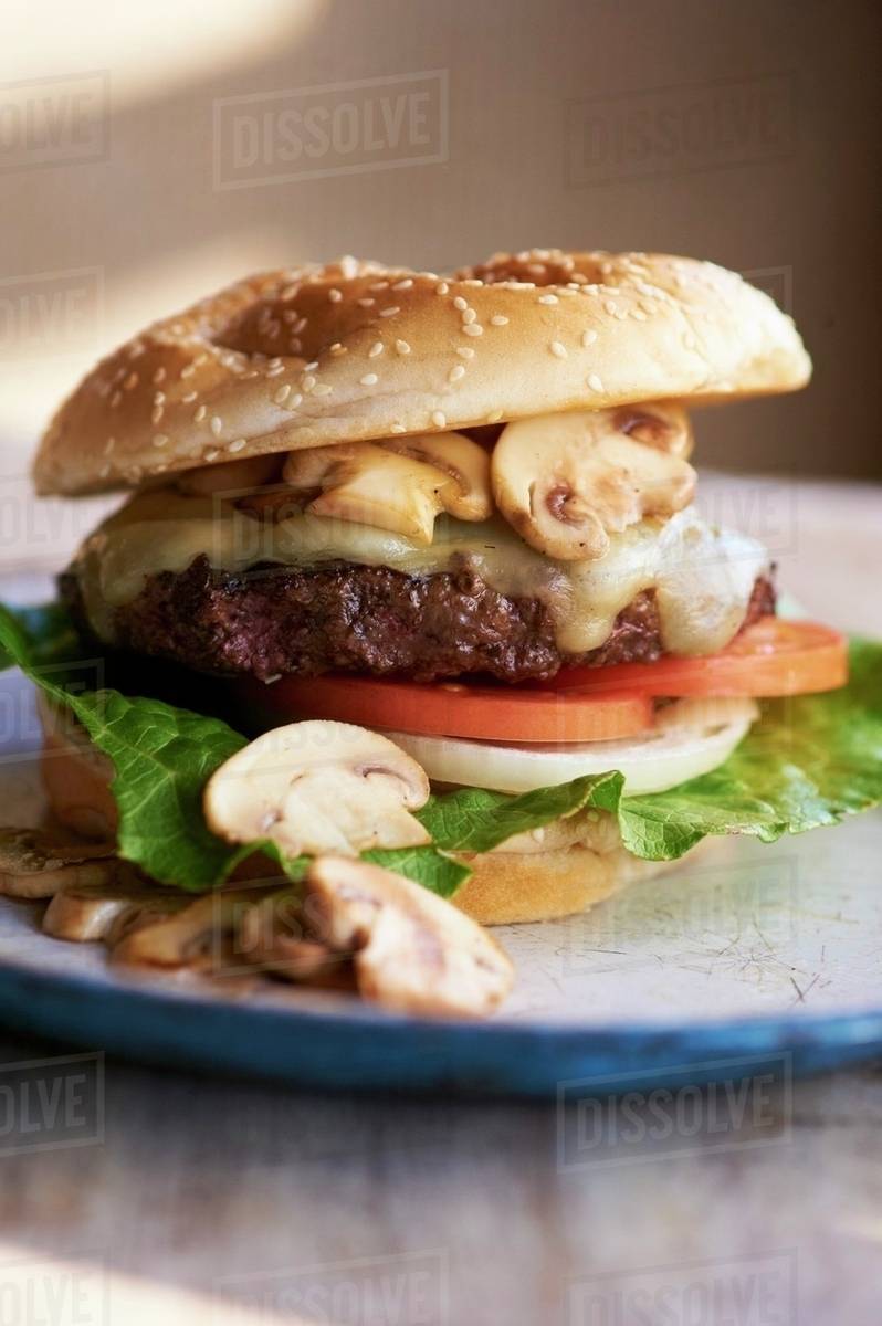 Swiss Cheese Burger with Mushrooms, Tomato, Onion and Lettuce on Sesame ...