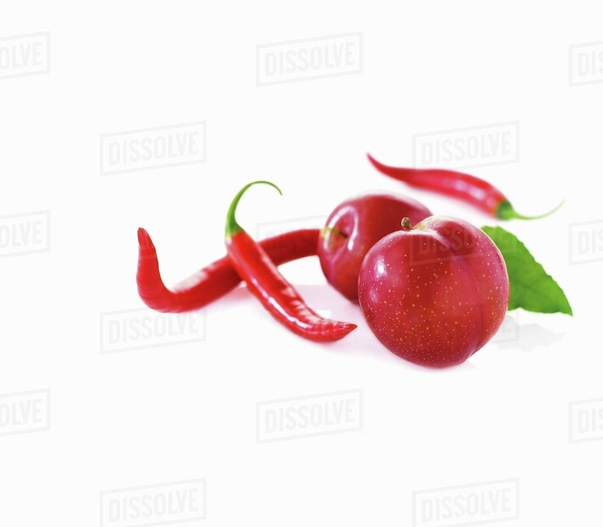 Red plums and chili peppers - Royalty-free Stock Photo | Dissolve