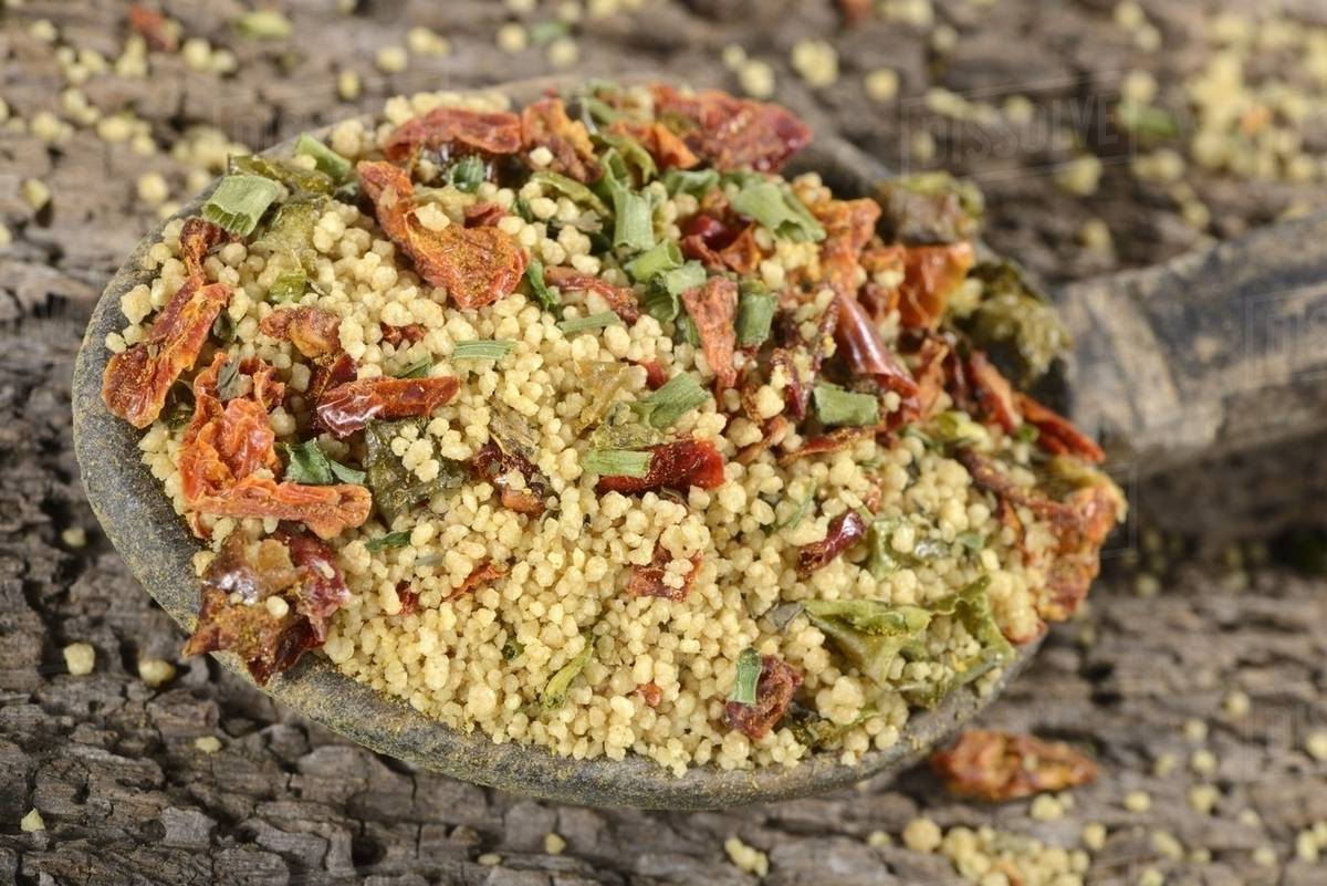 A ready-made mix of couscous with dried vegetables and spices - Stock ...