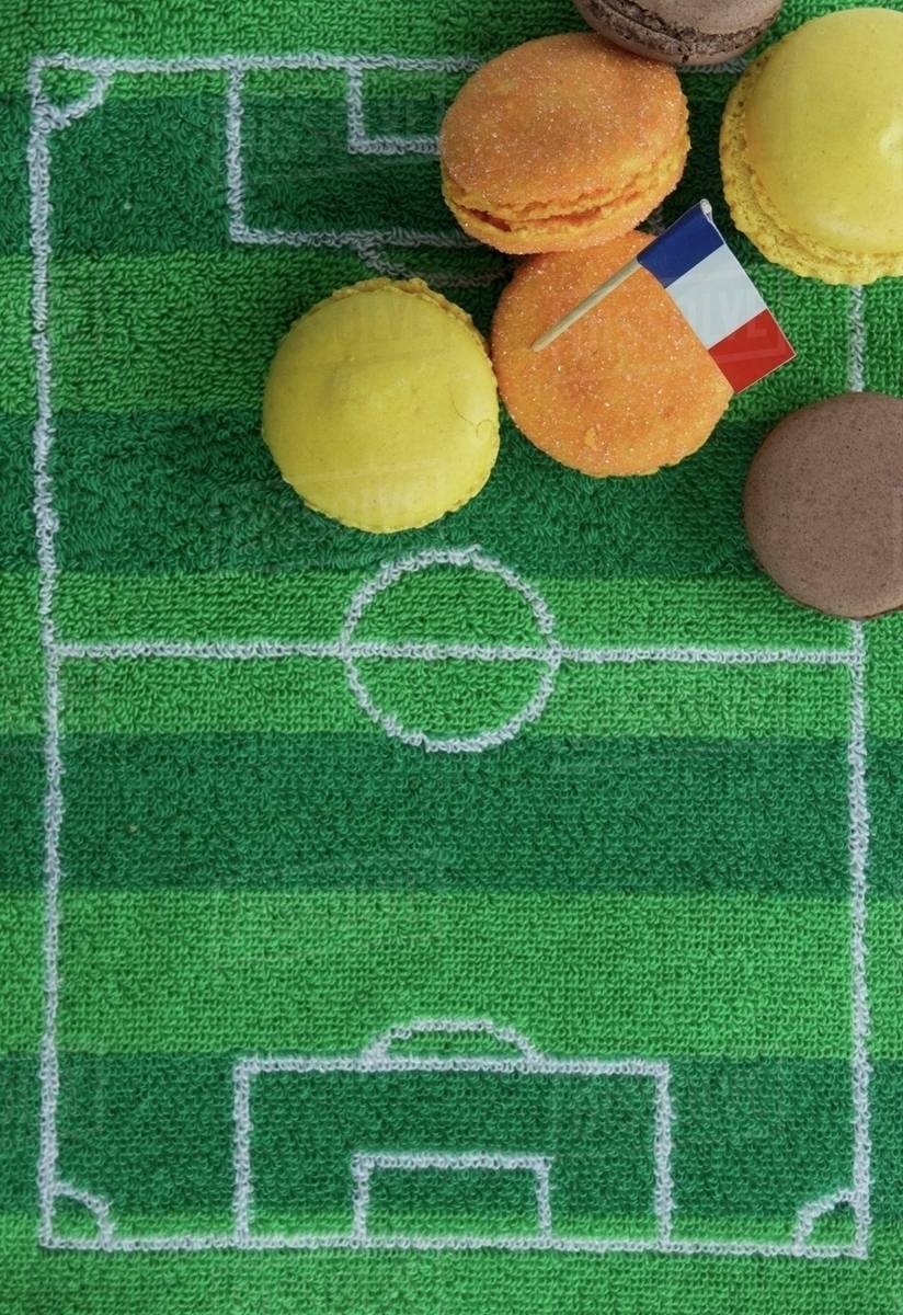 Macaroons (France) with a paper flag and football-themed decoration ...