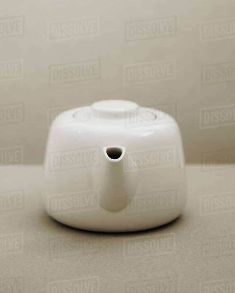 White teapot on a two-tone grey background - Stock Photo - Dissolve