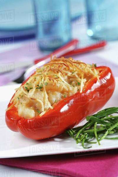 Red bell peppers stuffed with hake and shrimps - Stock Photo - Dissolve