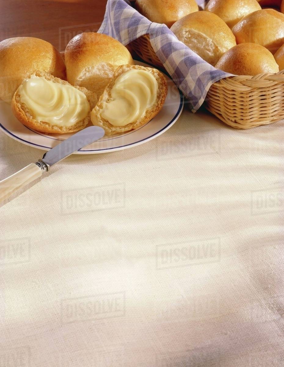 Dinner Rolls in a Basket; Some on a Plate with Butter - Stock Photo ...