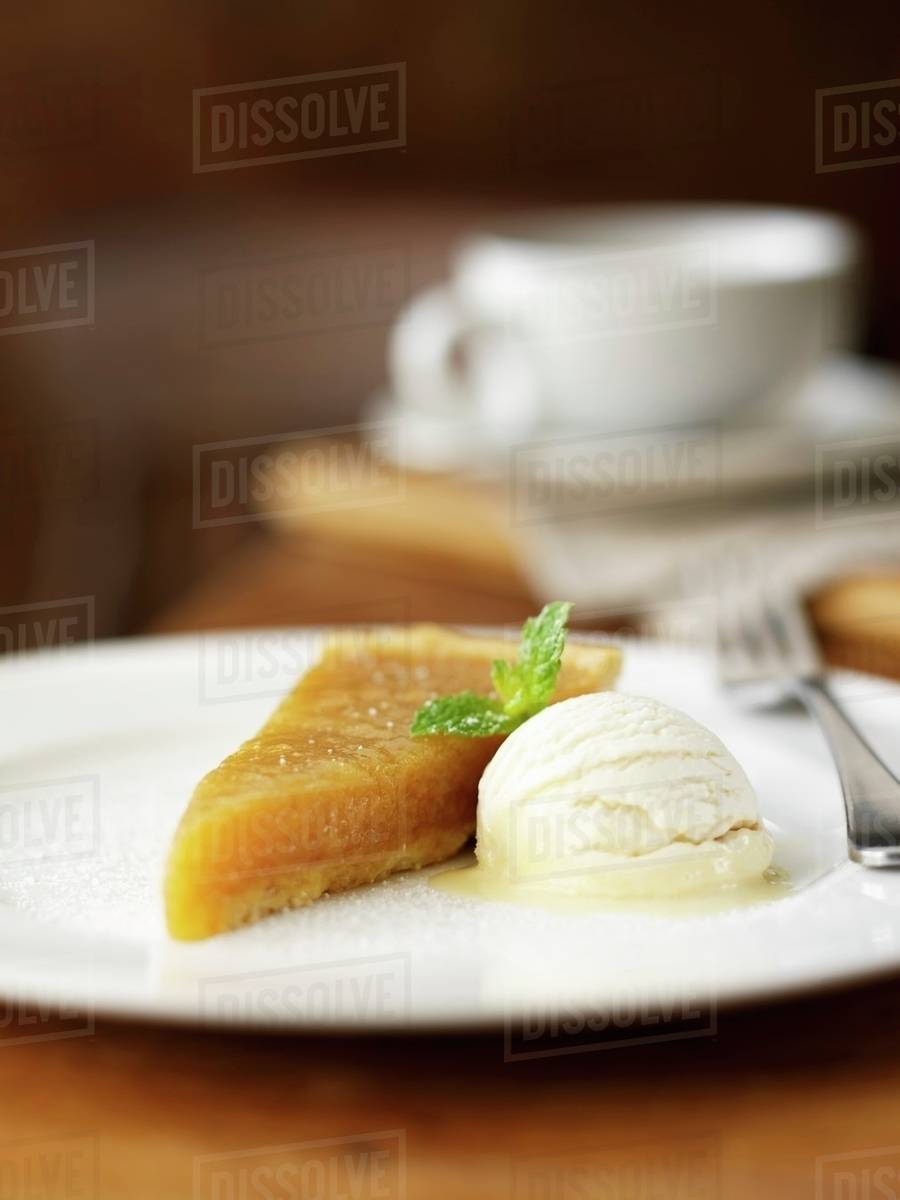 A piece of treacle tart with vanilla ice cream (UK) - Royalty-free ...