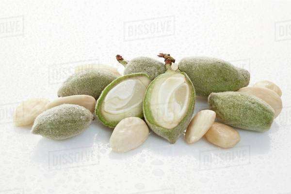 Raw almonds and almond hulls - Stock Photo - Dissolve