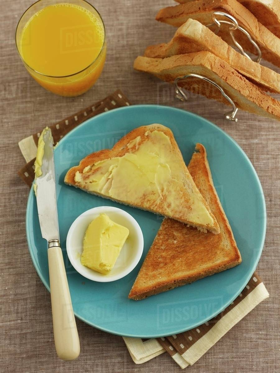Toast triangles with butter and orange juice - Royalty-free Stock Photo ...
