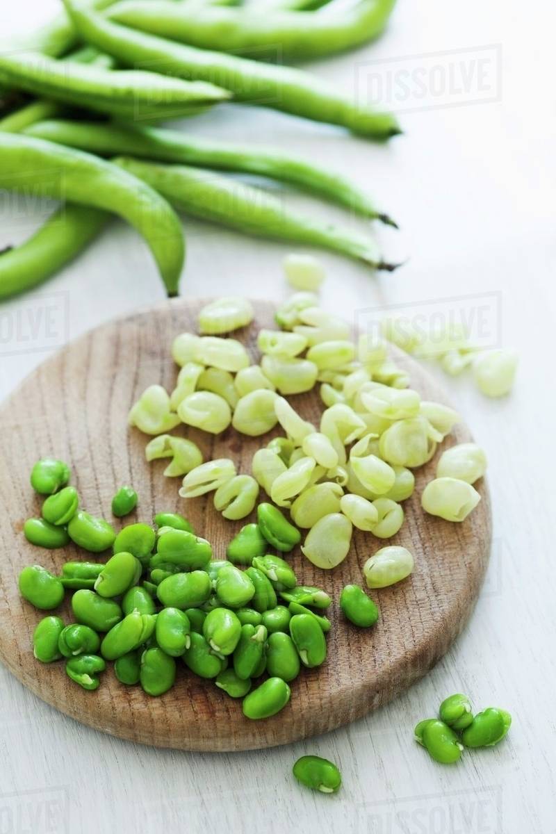 Broad beans with pods and empty skins - Royalty-free Stock Photo | Dissolve