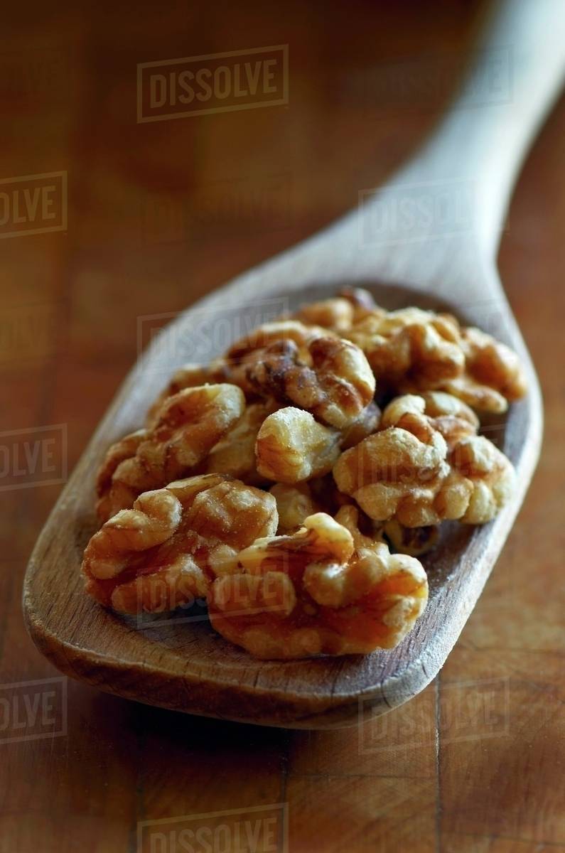 Walnuts on a Wooden Spoon - Stock Photo - Dissolve