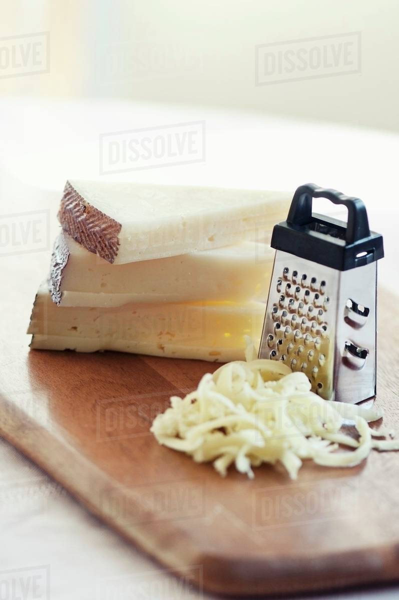 Wedges of Cheese with a Cheese Grater and Shredded Cheese - Stock Photo ...