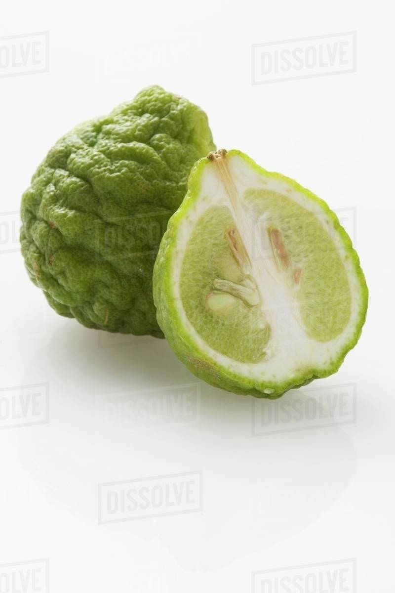 Kefir limes, whole and halved - Royalty-free Stock Photo | Dissolve
