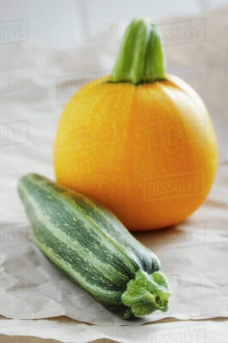A round yellow and a green stripy courgette - Royalty-free Stock Photo ...