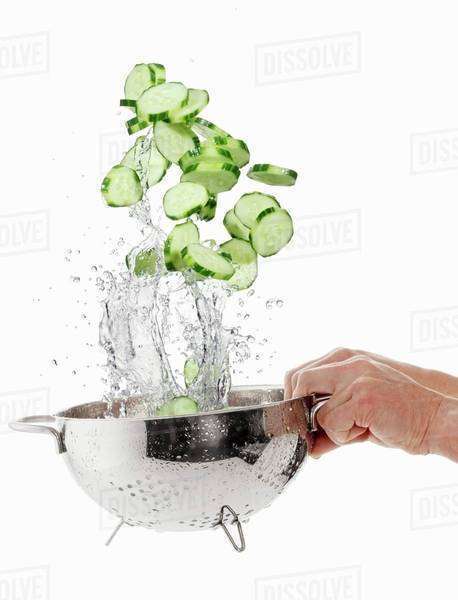 Cucumber slices being washed in a sieve - Royalty-free Stock Photo ...