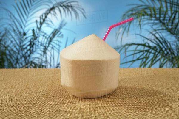 A Peeled Coconut with a Straw - Royalty-free Stock Photo | Dissolve