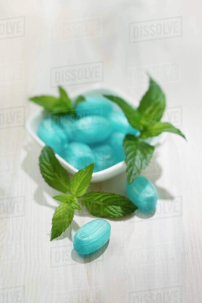 Blue mint bonbons and fresh mint - Royalty-free Stock Photo | Dissolve