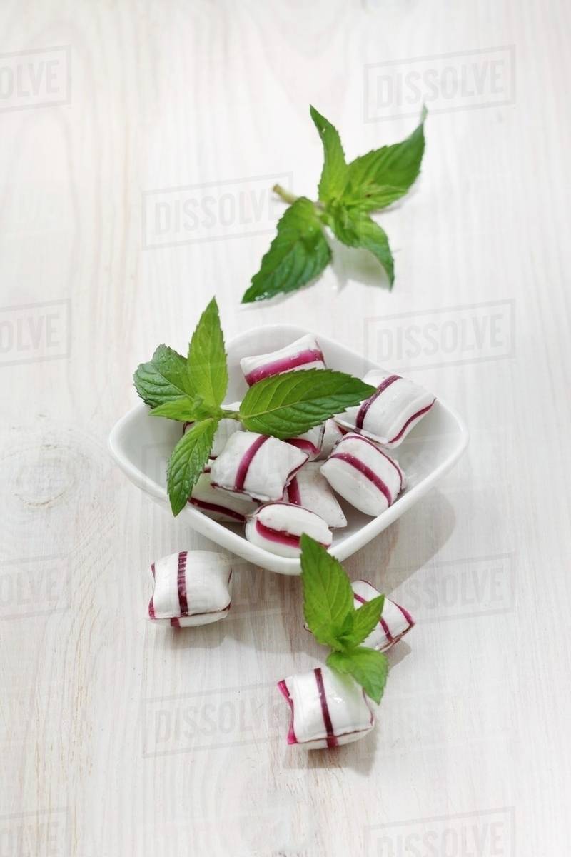 Peppermint bonbons and fresh mint - Royalty-free Stock Photo | Dissolve