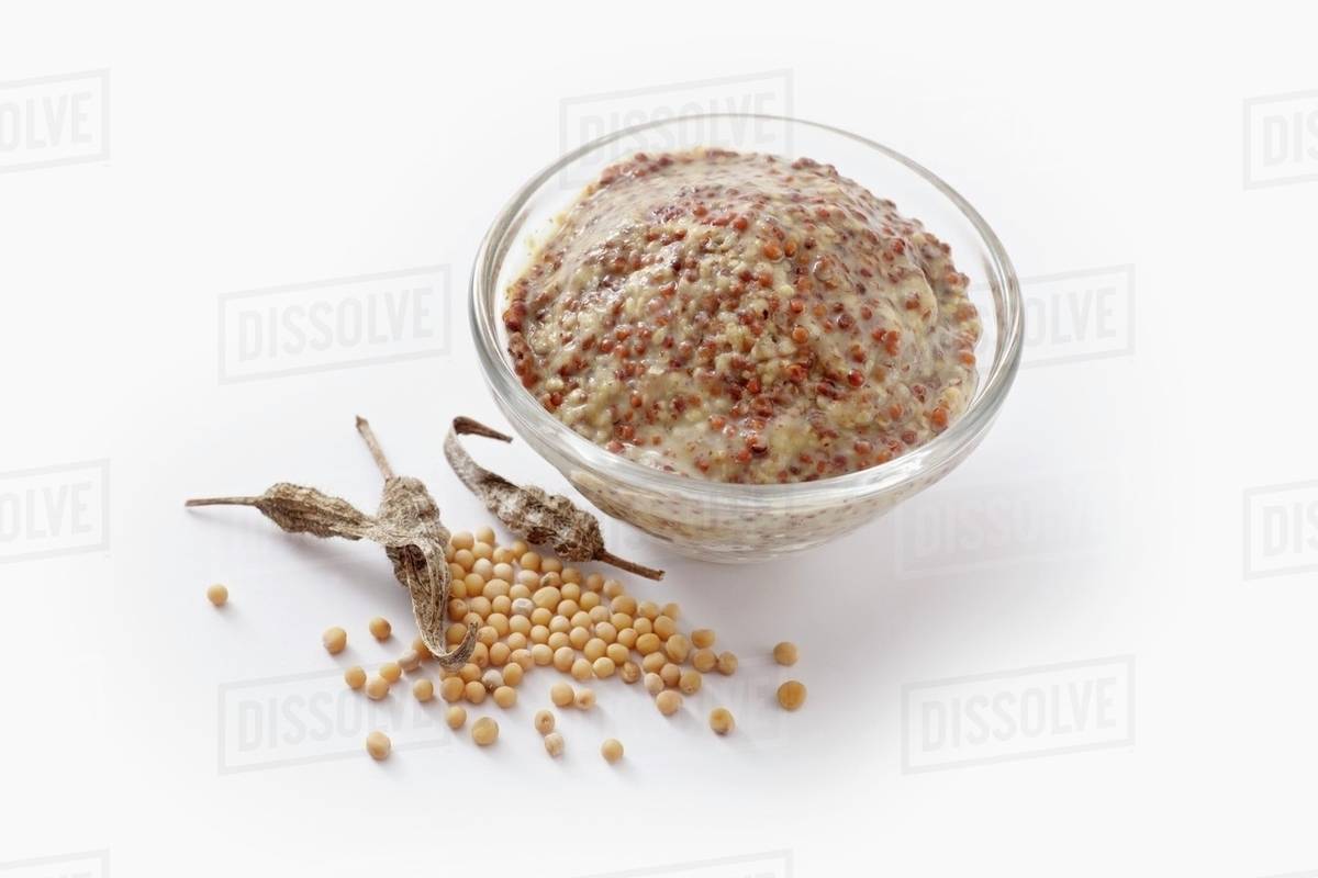 Mustard seeds, whole and ground - Stock Photo - Dissolve