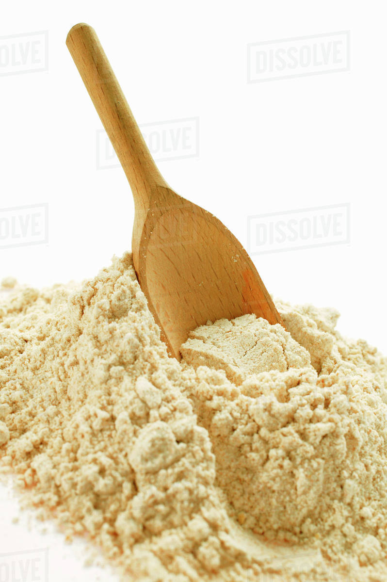 Wholemeal flour with wooden scoop - Royalty-free Stock Photo | Dissolve